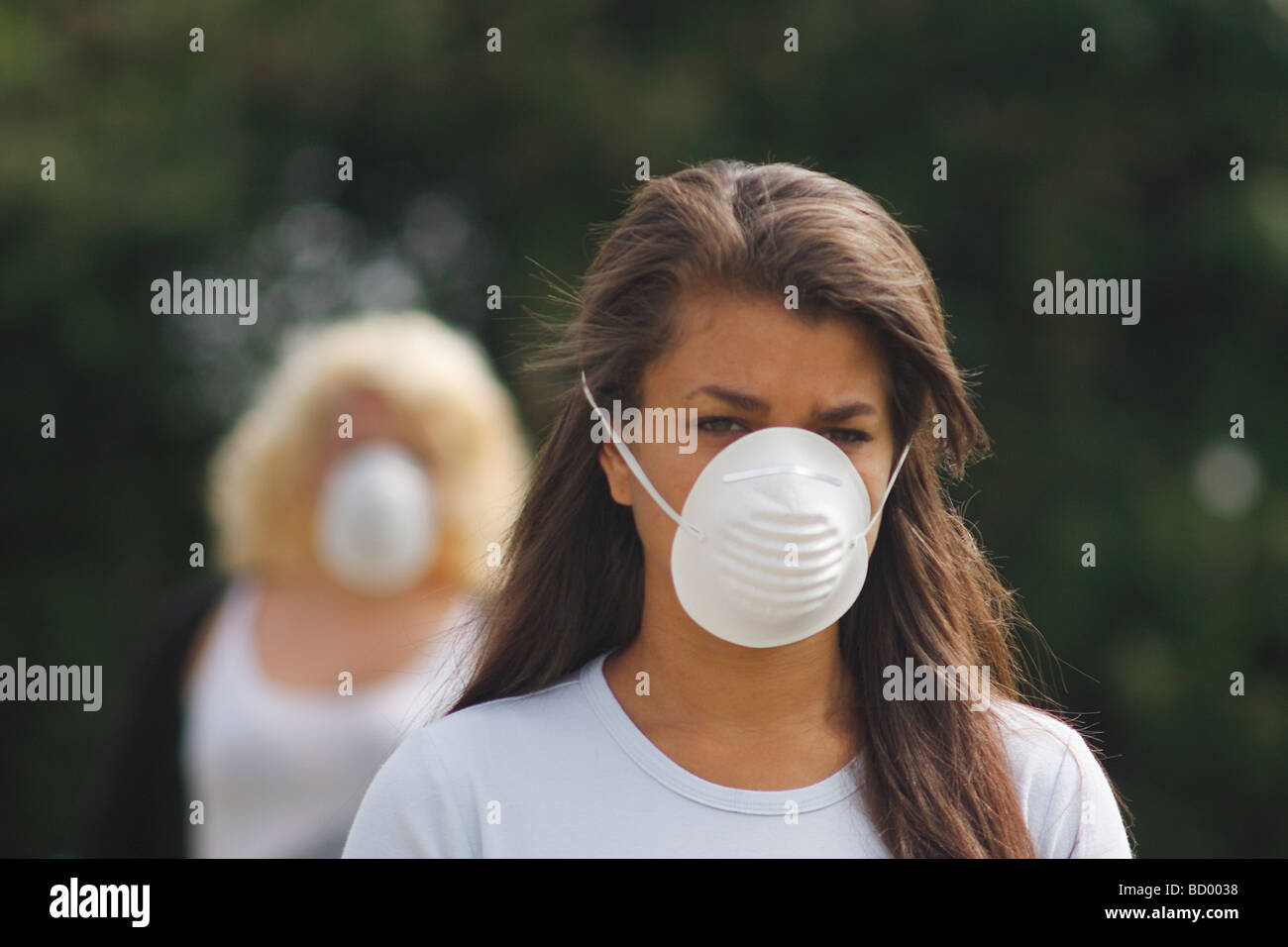 two young women in street wearing filter masks, anti pollution, virus ...
