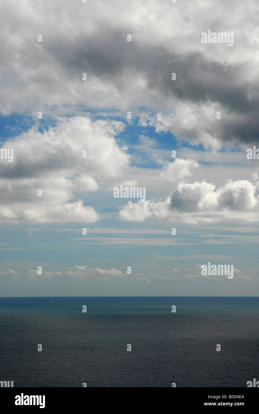 storm clouds reflecting in calm, open sea Stock Photo - Alamy