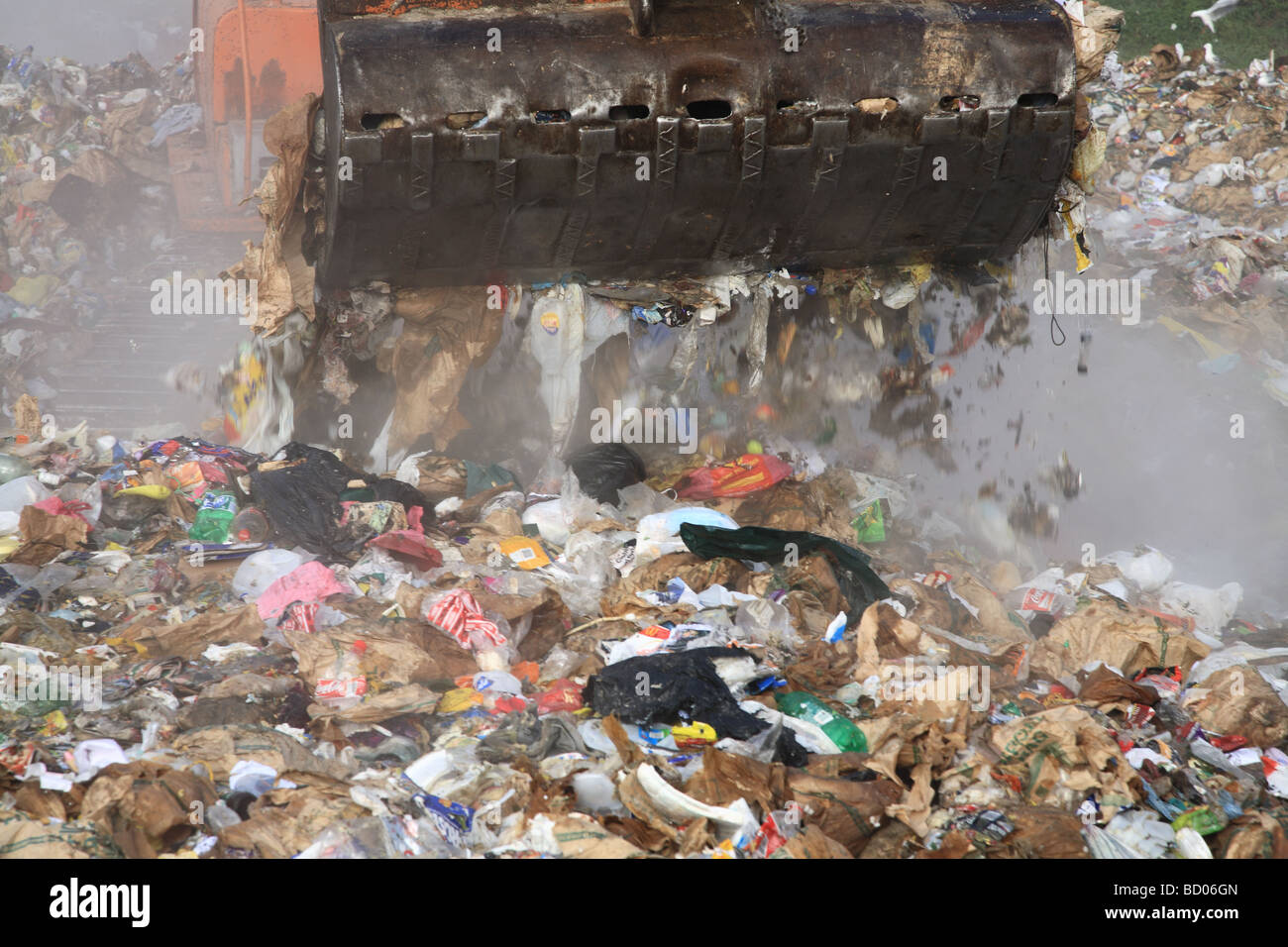 Backhoe atop Trash Stock Photo - Alamy