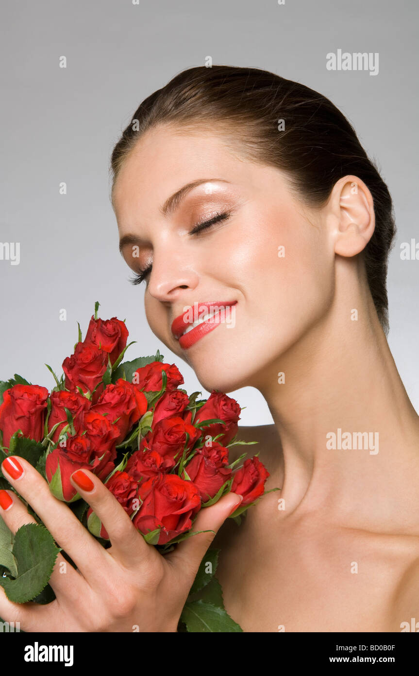 Female beauty model smelling roses Stock Photo - Alamy