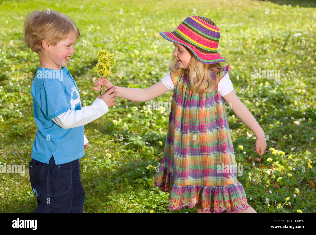 girl giving spring flower bouquet to boy Stock Photo - Alamy