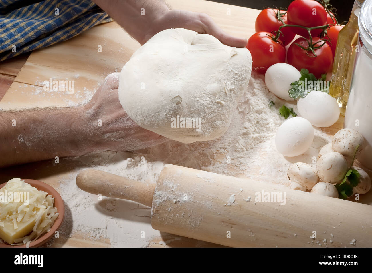 Overhead shot of a person kneading dough on wooden table Stock Photo ...