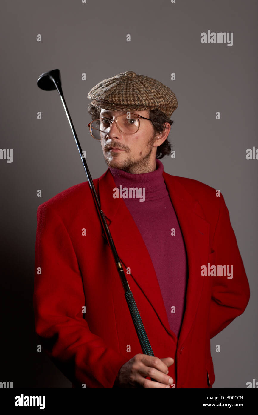 Studio portrait of a golfer in red blazer and cap, with golf club Stock ...