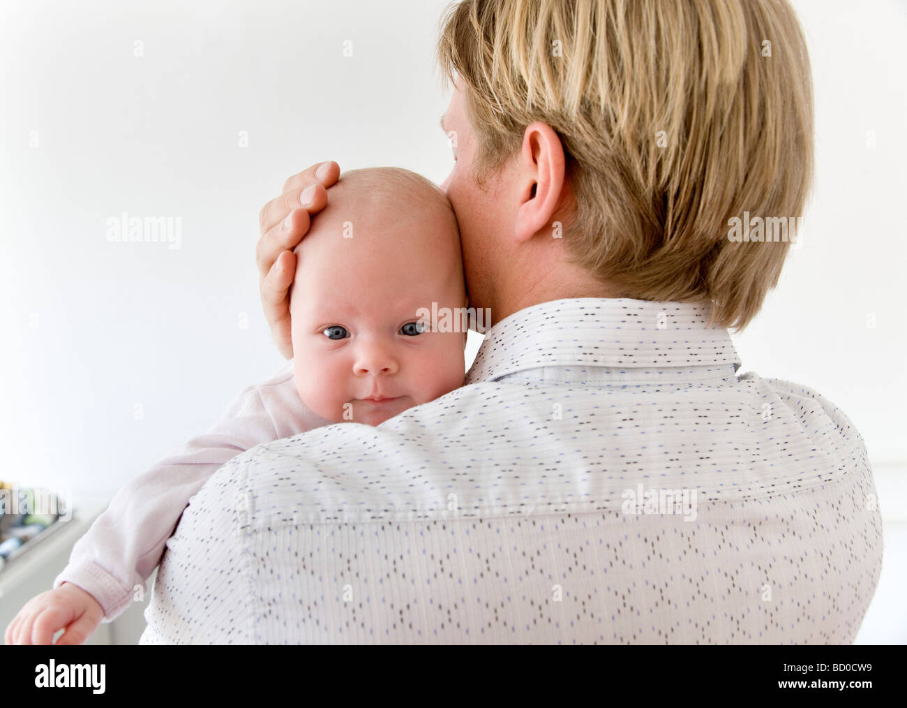 father carrying baby on shoulder Stock Photo - Alamy