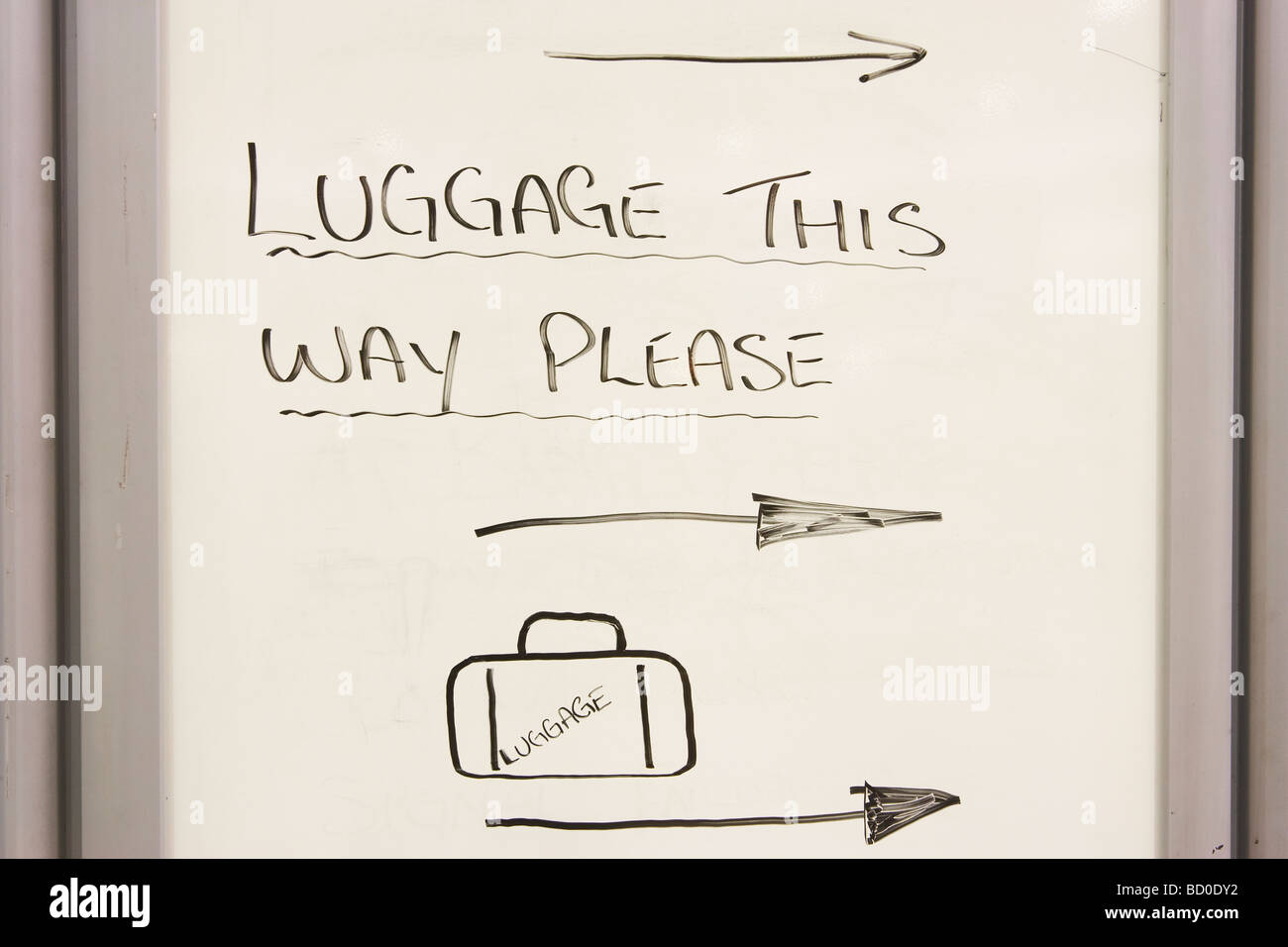 Luggage this way please, white board sign in a station Stock Photo - Alamy