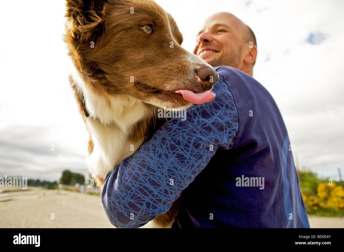 Man hugging his dog, Jericho Beach, Vancouver, British Columbia Stock ...