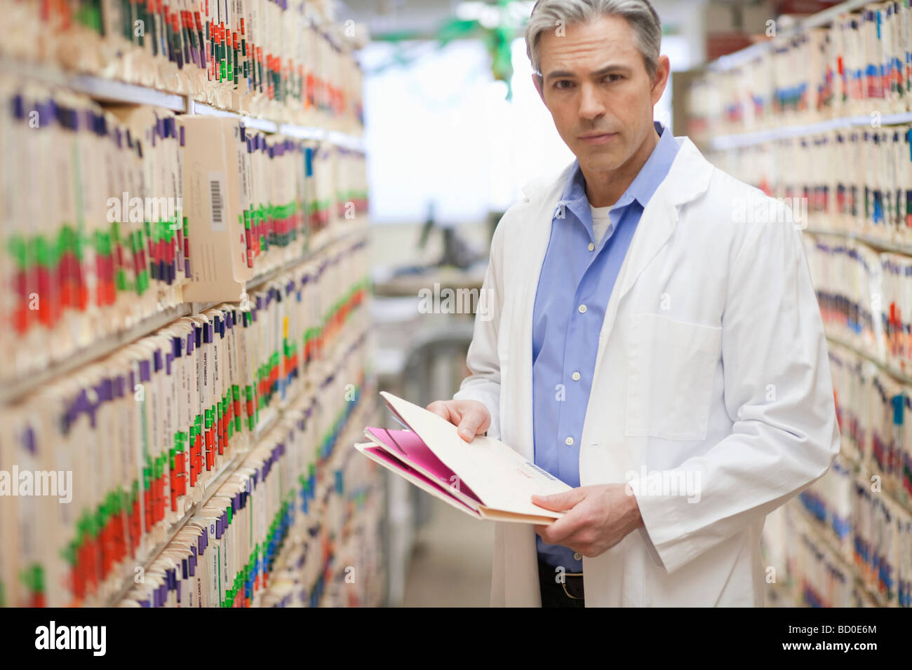 Male Doctor holding medical file Stock Photo - Alamy