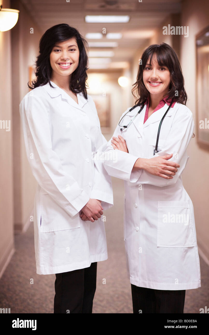 2 Females Doctors smiling Stock Photo - Alamy