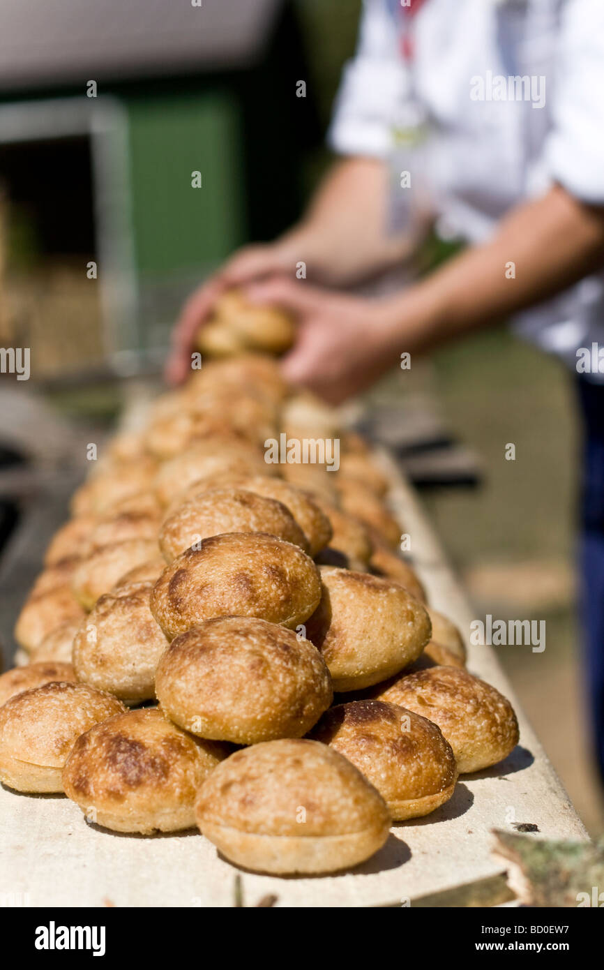 Round buns being set out on wooden plank outdoors Stock Photo - Alamy