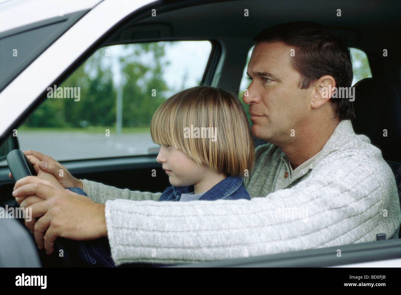 Boy driving fathers car hi-res stock photography and images - Alamy