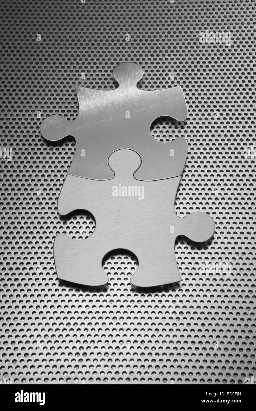 Metal jigsaw puzzle pieces Stock Photo - Alamy