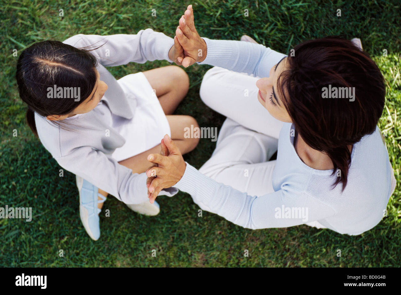 Mother and daughter playing clapping game, viewed from directly above Stock Photo - Alamy