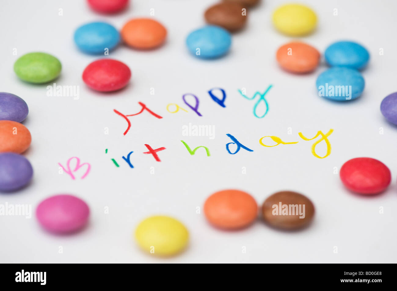 Happy birthday and chocolate smarties Stock Photo - Alamy