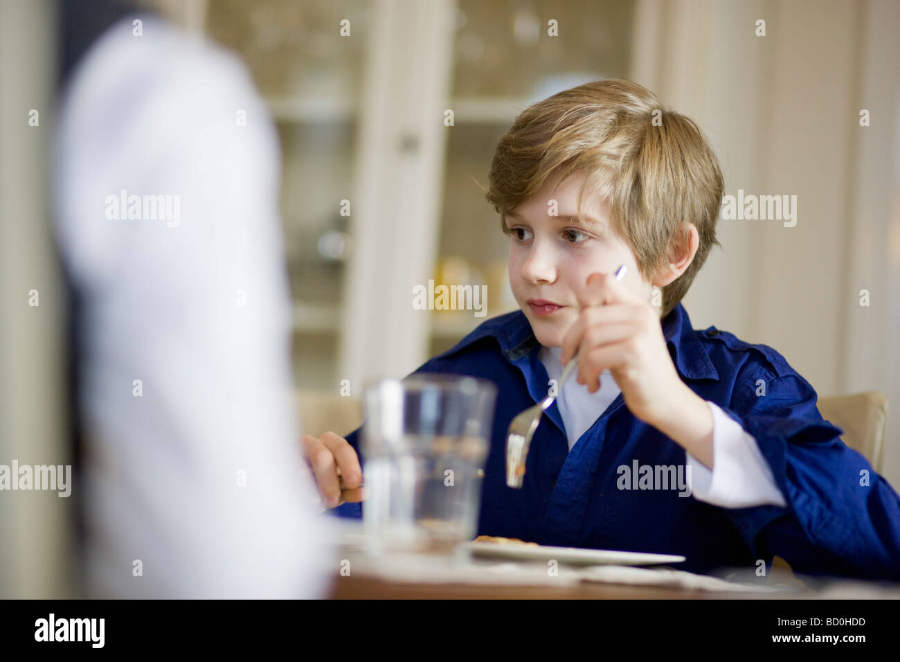 boy at table eating Stock Photo - Alamy
