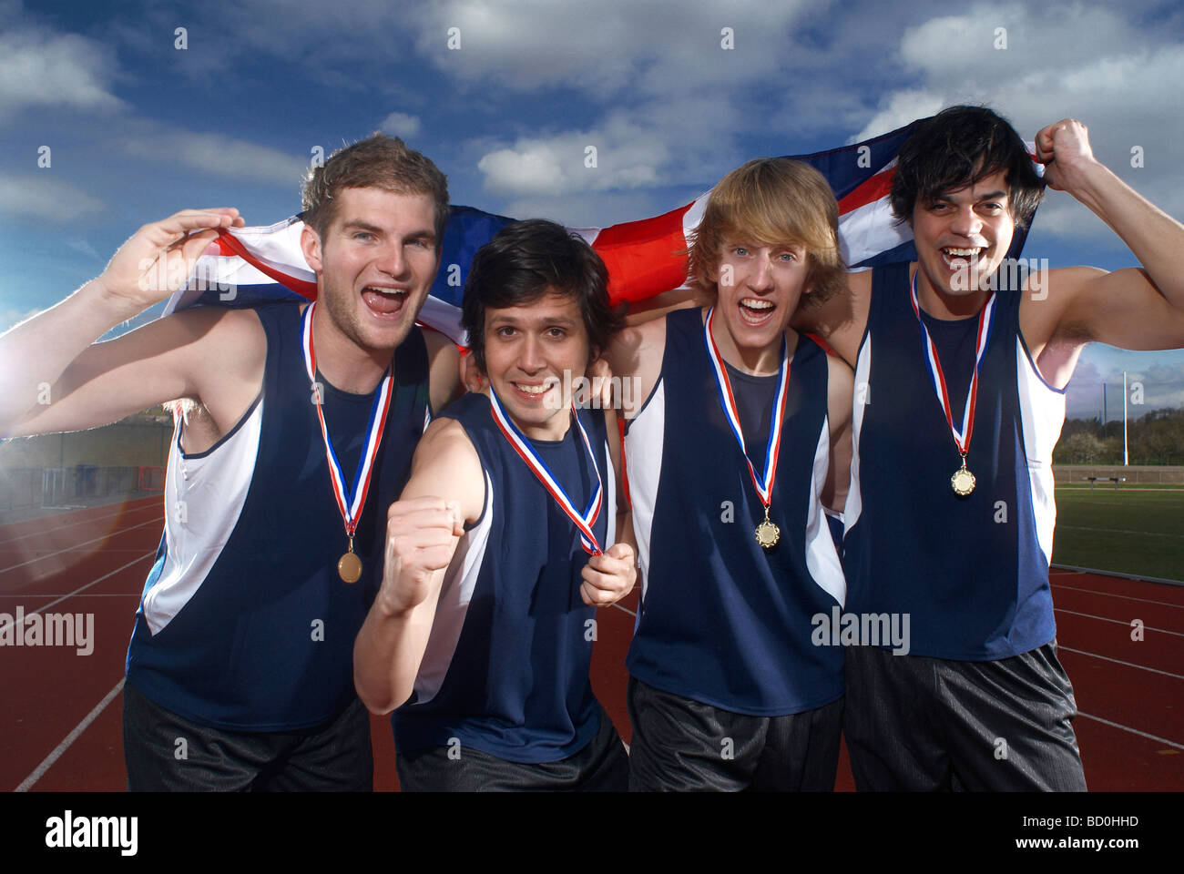 Four happy young athletes hi-res stock photography and images - Alamy