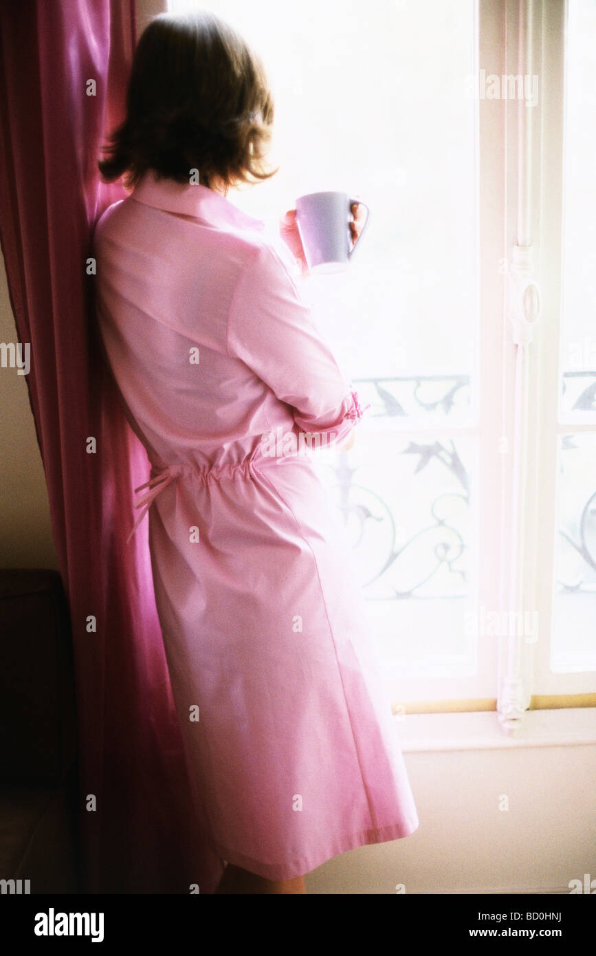 Backlit woman looking out window hi-res stock photography and images ...