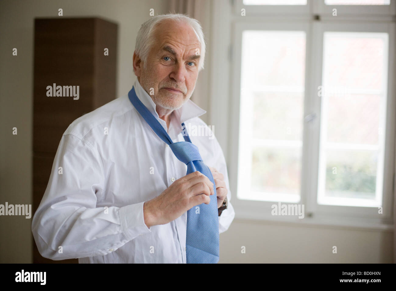 Old man putting on clothes hi-res stock photography and images - Alamy