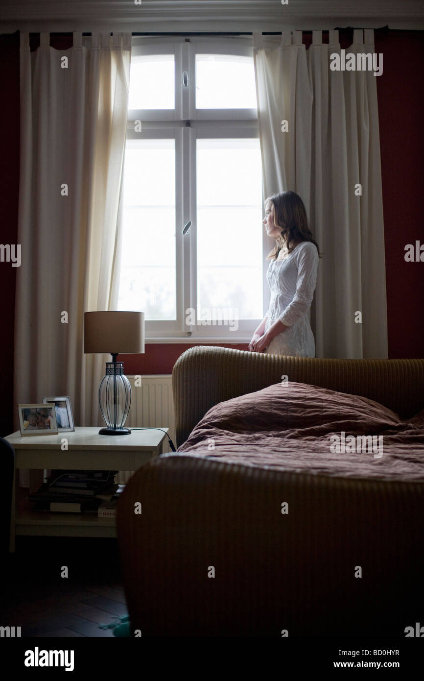 girl looking out of a window Stock Photo - Alamy