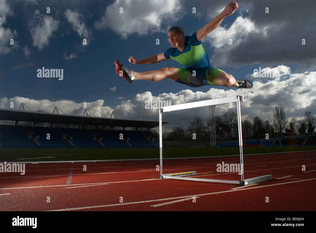athlete jumping hurdle Stock Photo - Alamy