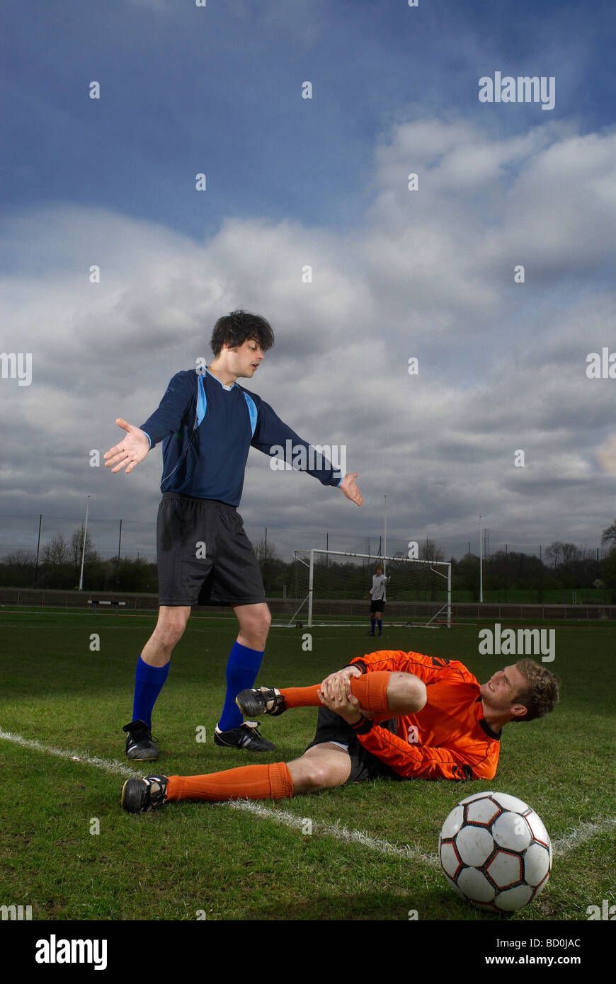 footballer fouled by another player Stock Photo - Alamy