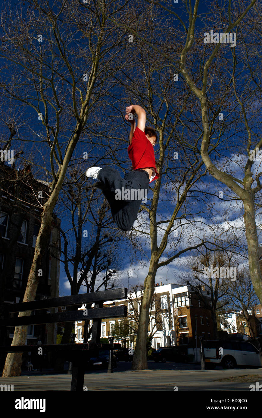 man jumping over bench Stock Photo - Alamy