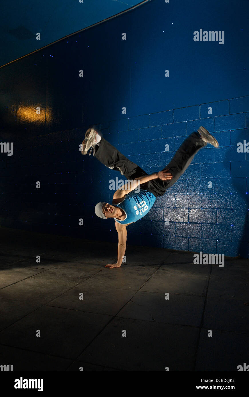 man doing one hand stand Stock Photo - Alamy
