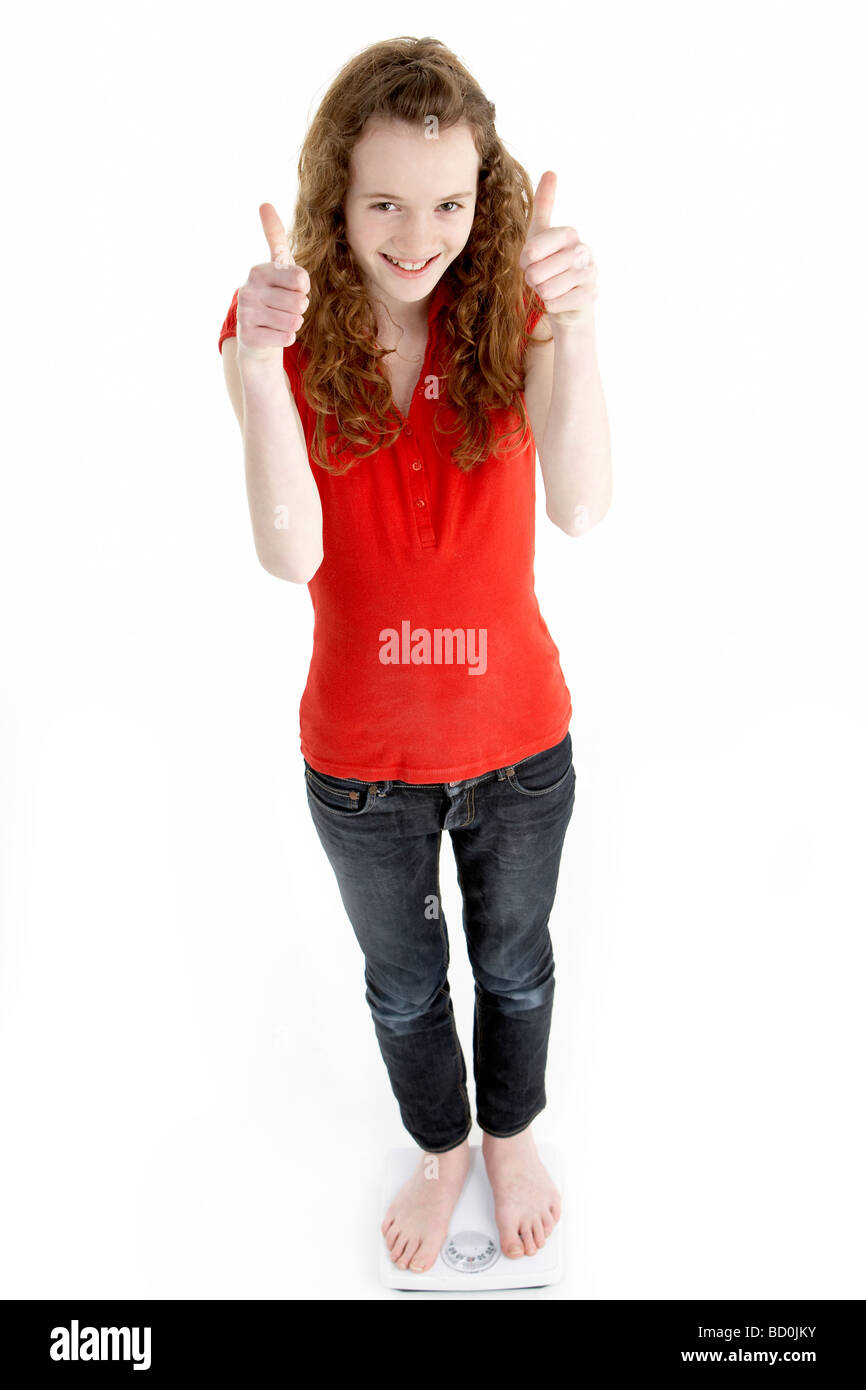 Happy Young Girl Standing On Scales Stock Photo - Alamy