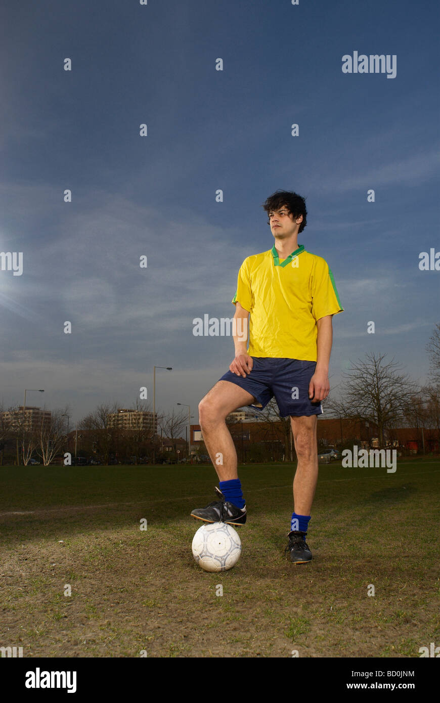 footballer standing with ball Stock Photo - Alamy