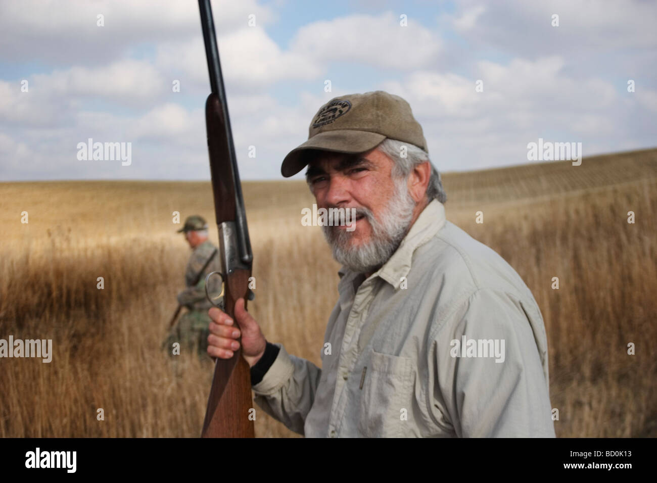 Experienced hunter John Davidson hunting with his shotgun at the ready ...