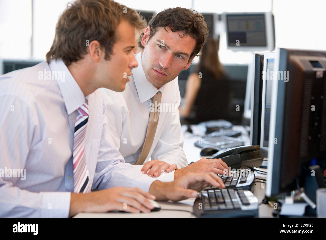 Colleagues Working Together At Computer Stock Photo - Alamy