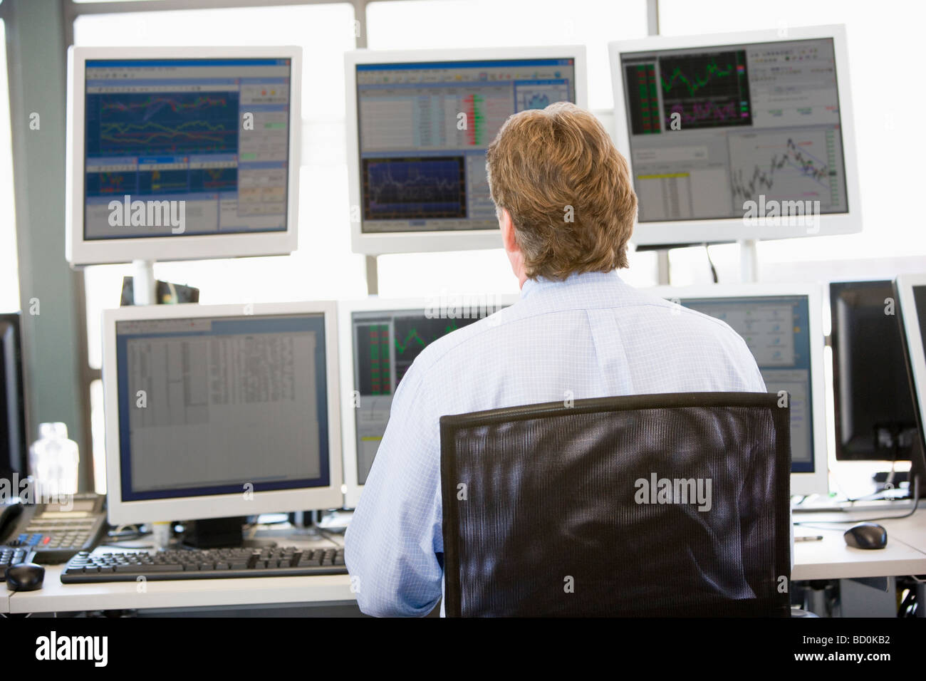 Stock Trader Looking At Multiple Monitors Stock Photo - Alamy