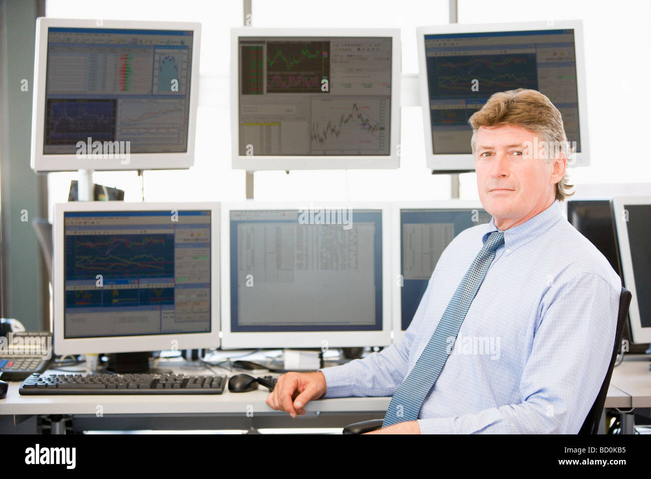 Portrait Of Stock Trader In Front Of Computer Monitors Stock Photo - Alamy