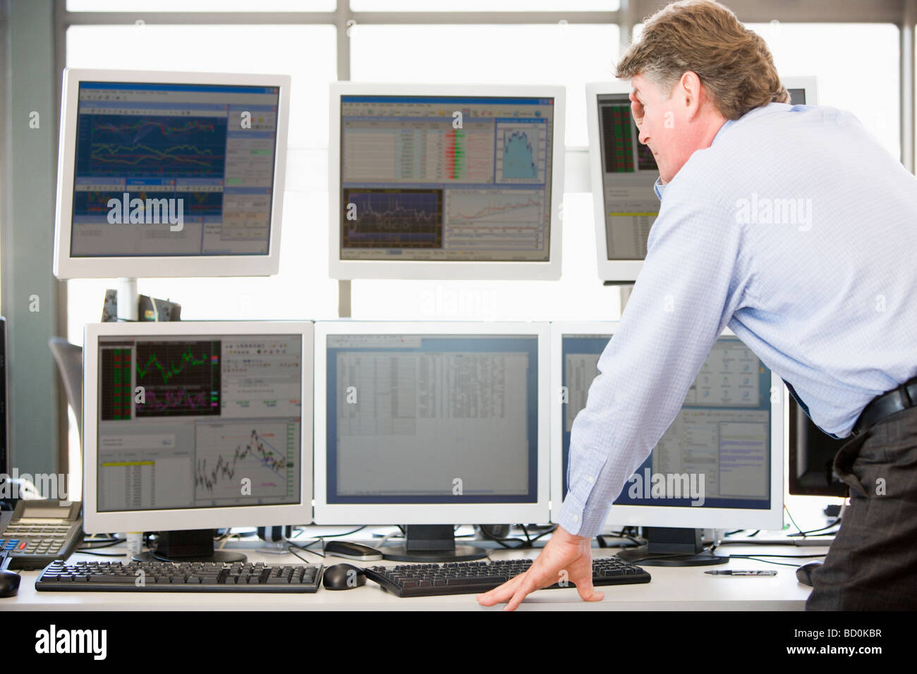 Stock Trader Examining Computer Monitors Stock Photo - Alamy