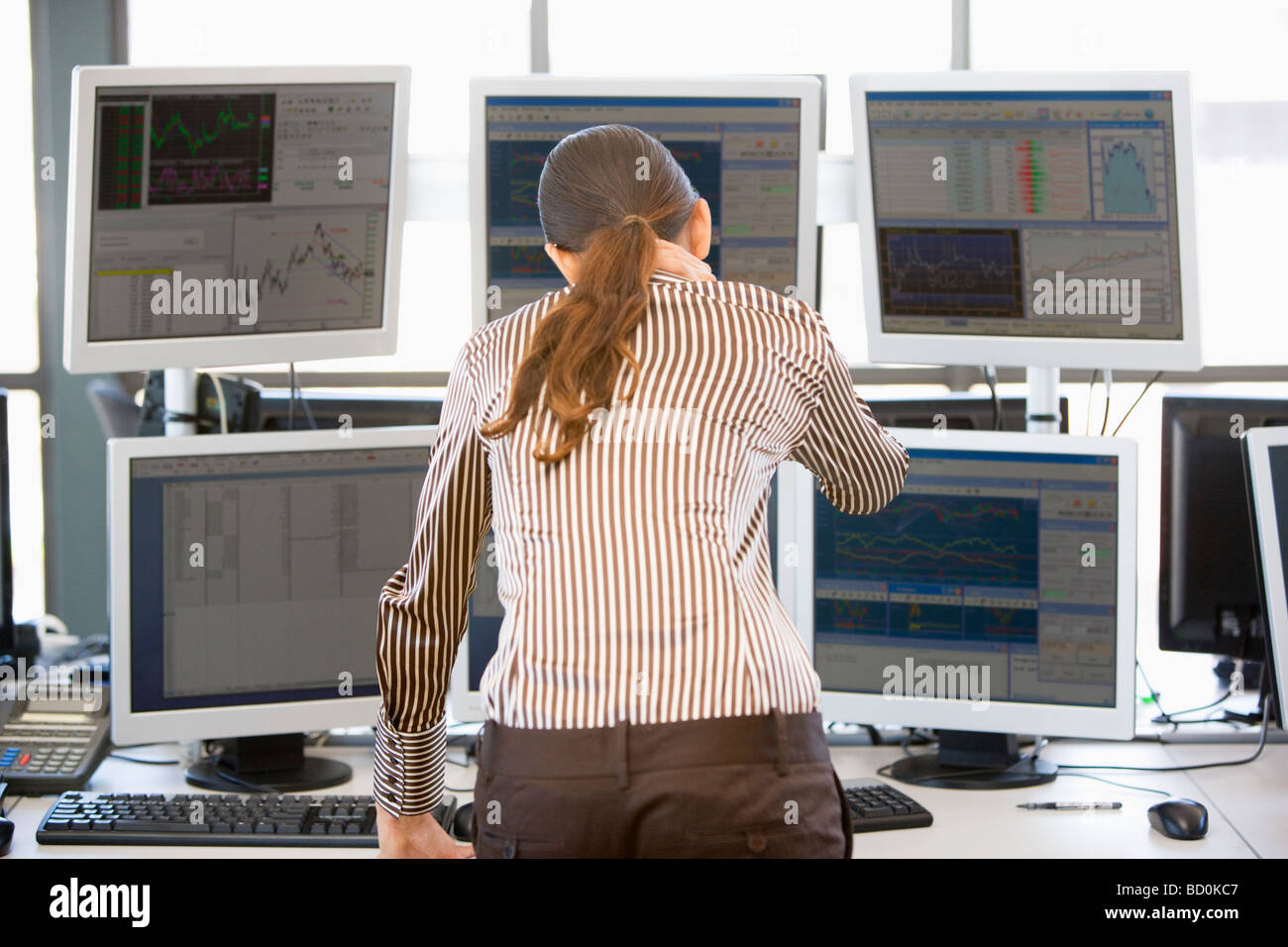 Stock Trader Looking At Multiple Monitors Stock Photo - Alamy