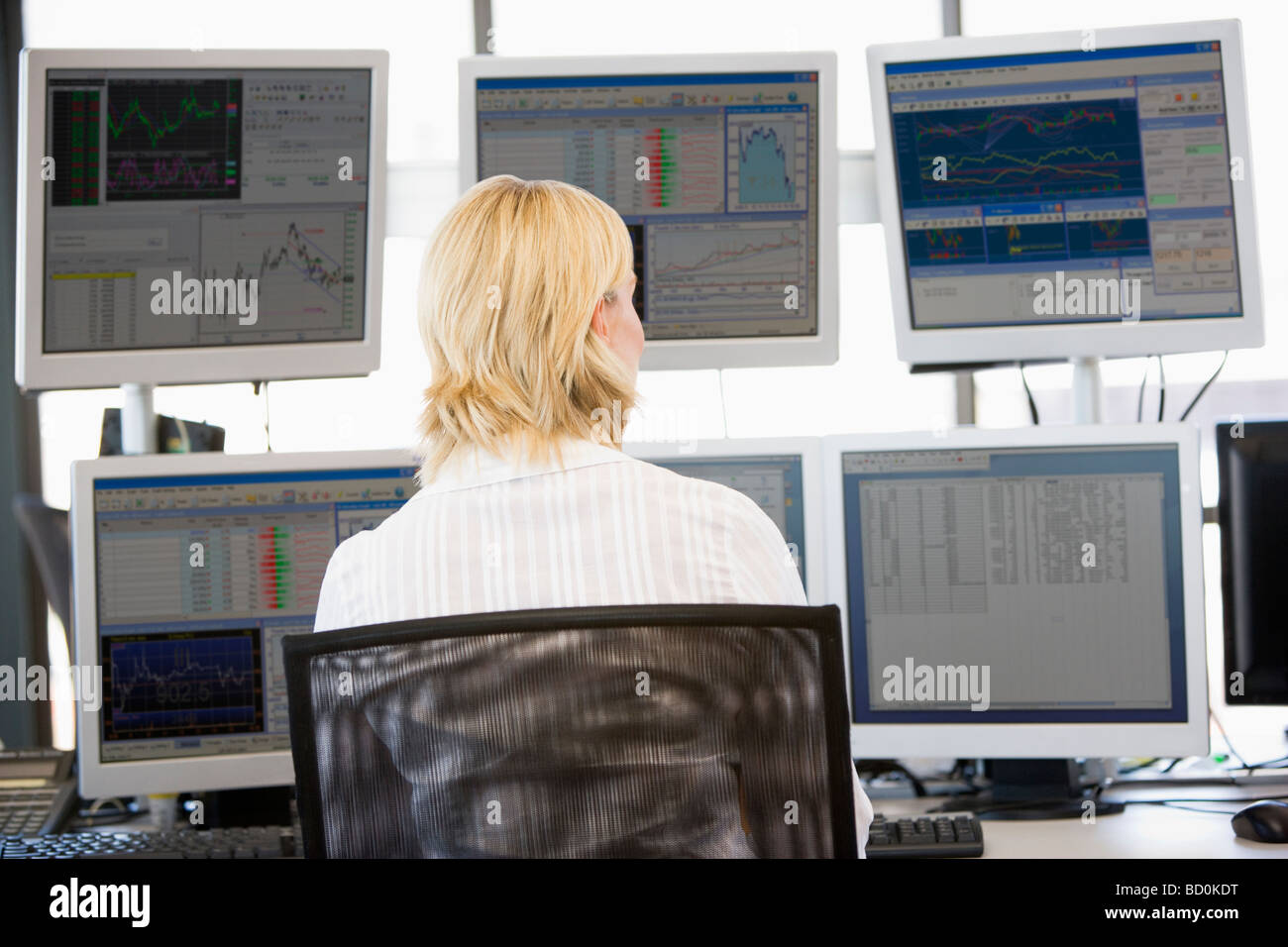 Stock Trader Looking At Multiple Monitors Stock Photo - Alamy