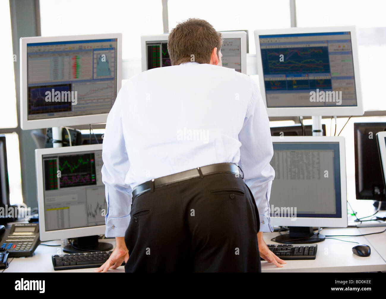 Stock Trader Looking At Multiple Monitors Stock Photo - Alamy