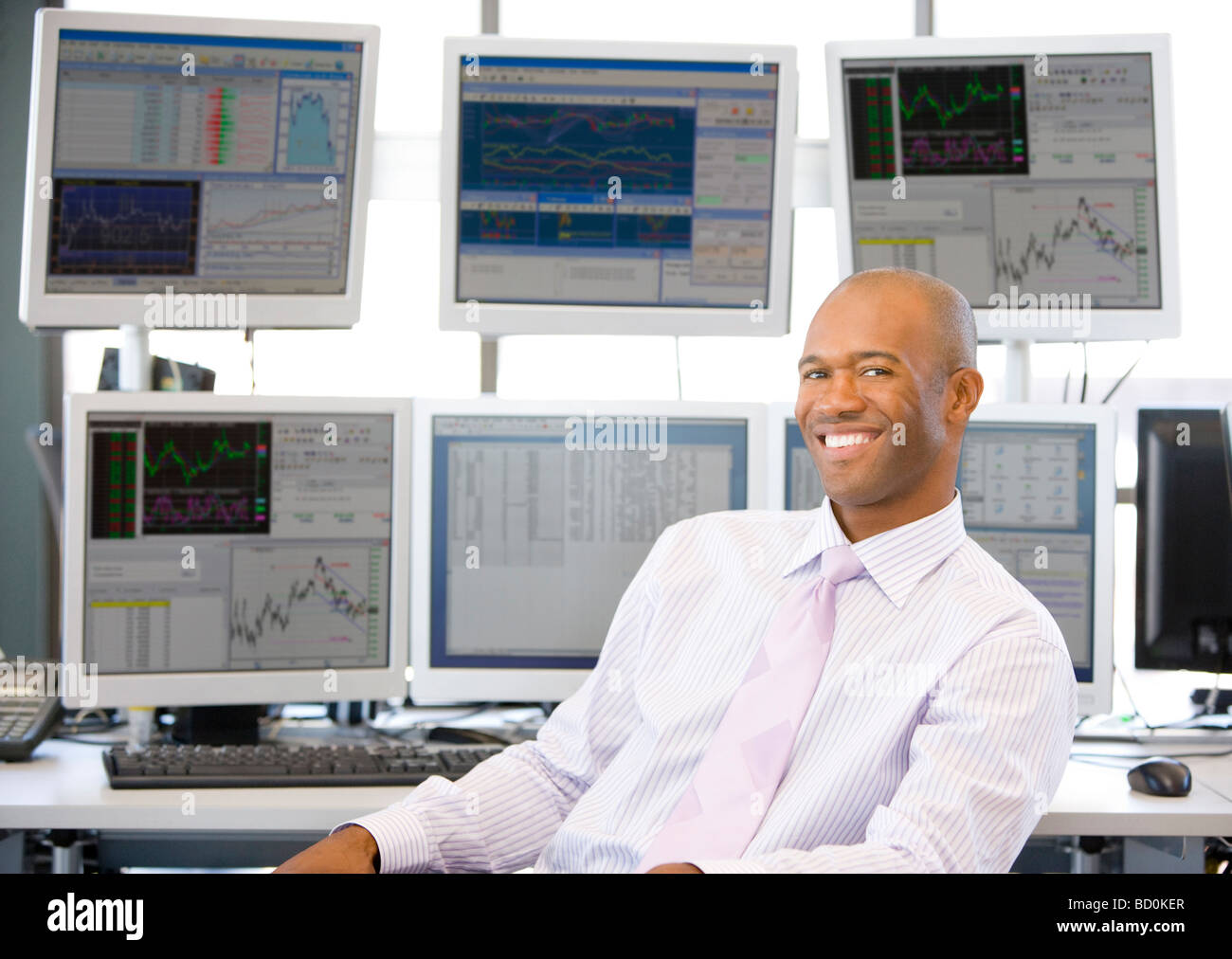 Portrait Of Stock Trader In Front Of Computer Monitors Stock Photo - Alamy
