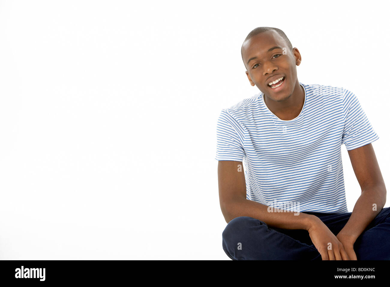 Teenage Boy Sitting In Studio Stock Photo - Alamy
