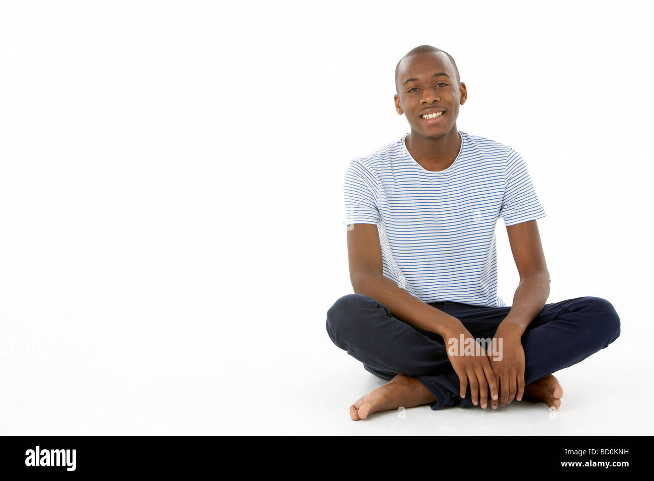 Teenage Boy Sitting In Studio Stock Photo - Alamy