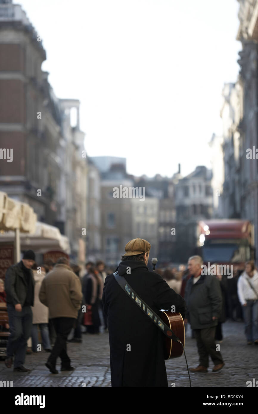 Man busking in a busy street Stock Photo - Alamy