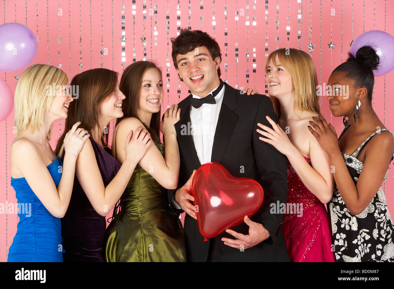 Teenage Girls Looking At Attractive Boy Stock Photo - Alamy