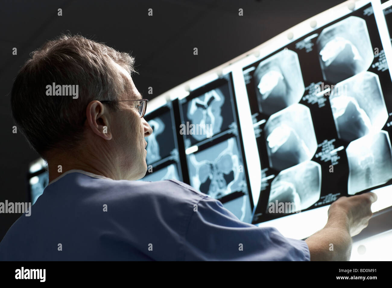 Doctor looking at x-rays Stock Photo - Alamy