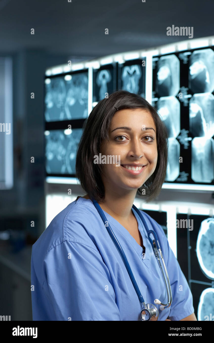 Female doctor smiling x rays behind hi-res stock photography and images ...
