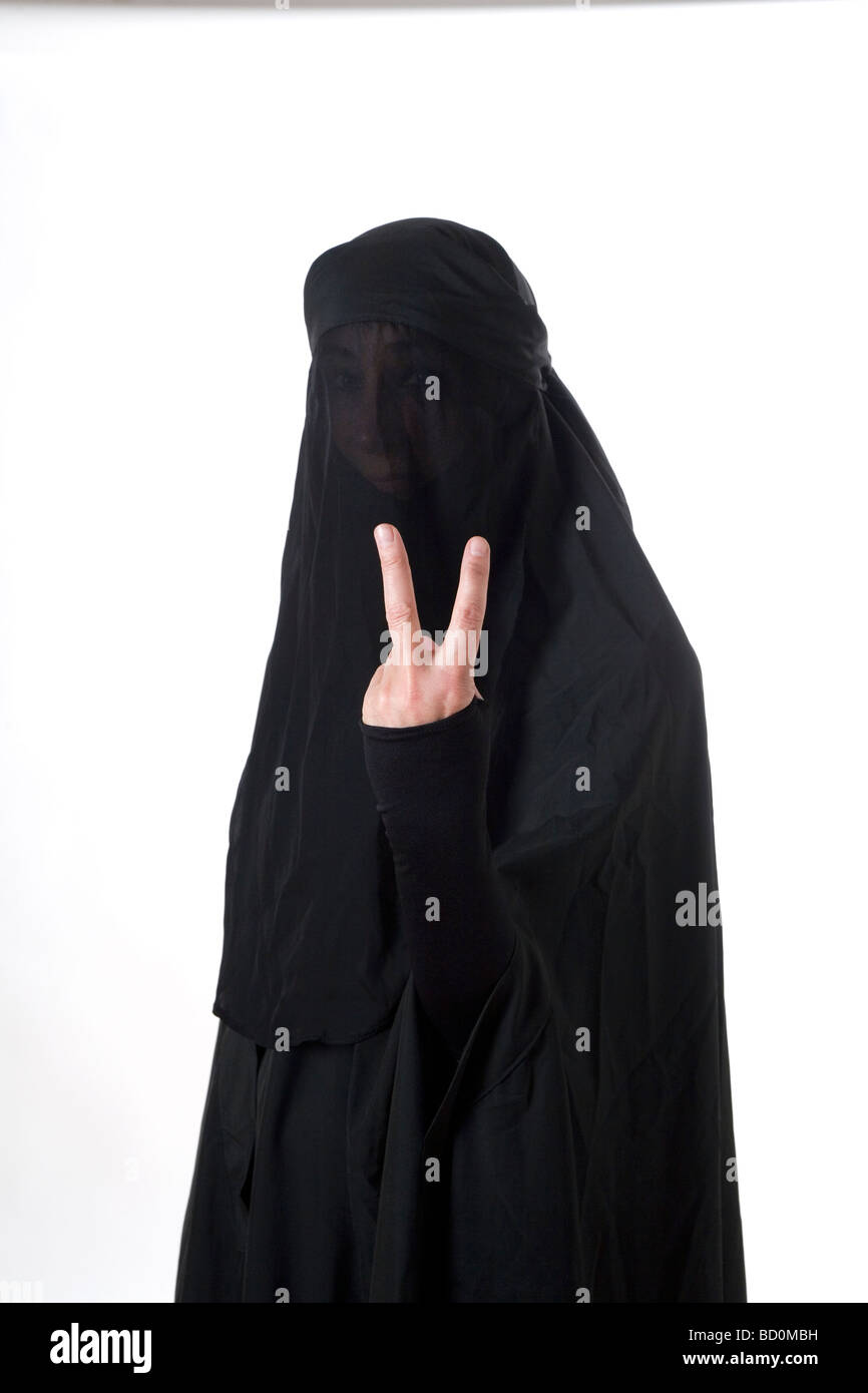 Islamic muslim woman wearing a burqa niqab burka and making a v sign ...