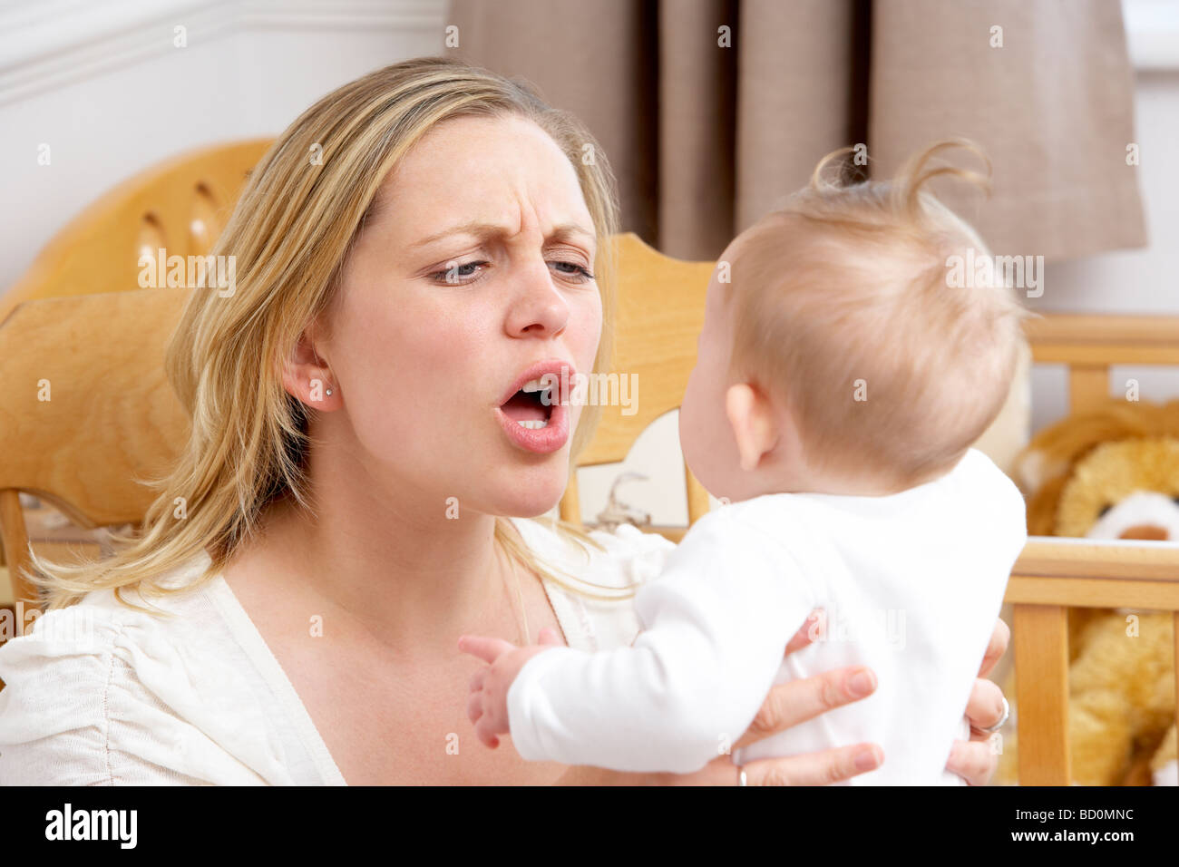 Stressed Mother Holding Baby In Nursery Stock Photo - Alamy