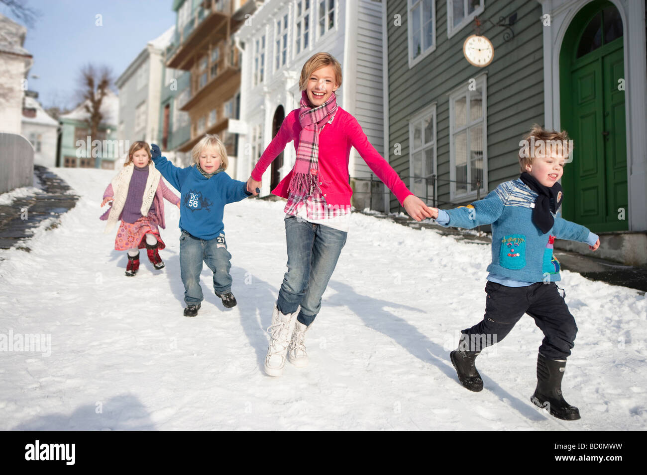 Scandinavian children running in snow Stock Photo - Alamy