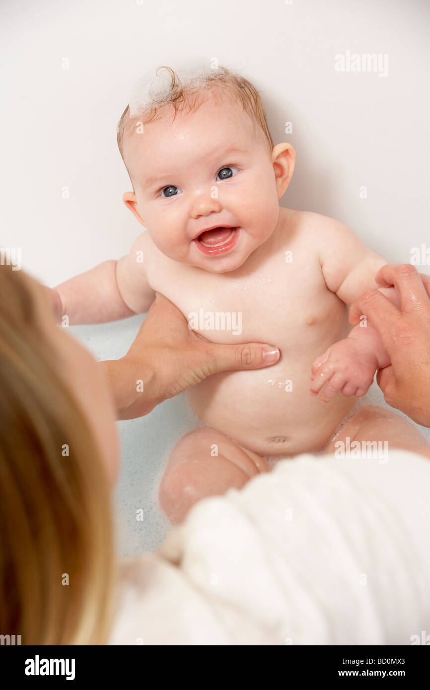 Mother Bathing Baby At Home Stock Photo - Alamy