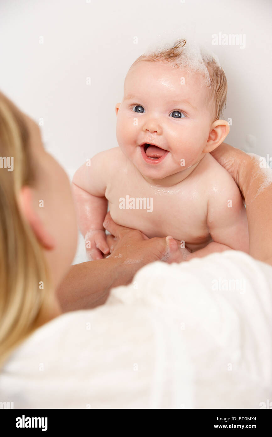 Mother Bathing Baby At Home Stock Photo - Alamy
