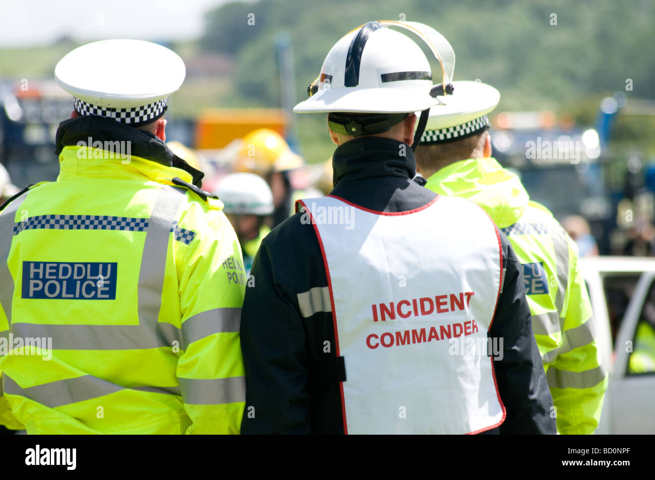 A traffic cop talks with an incident commander from a fire crew about a ...