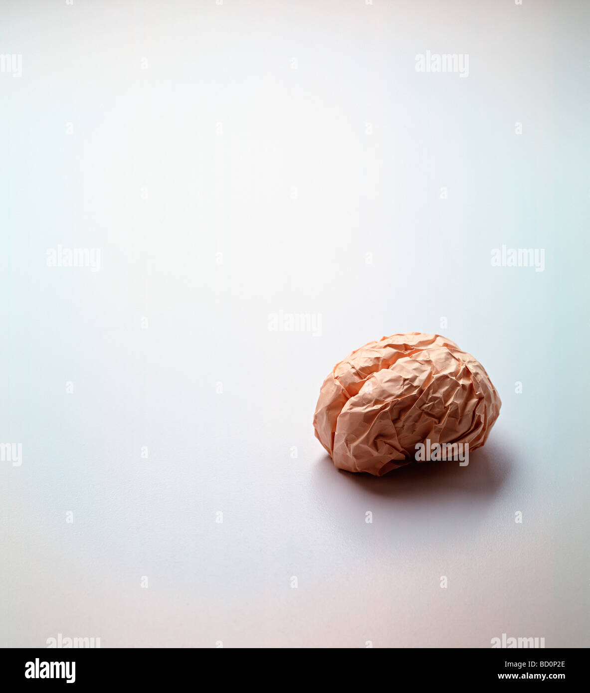 ball of paper in the shape of a brain on a blue toned background Stock ...